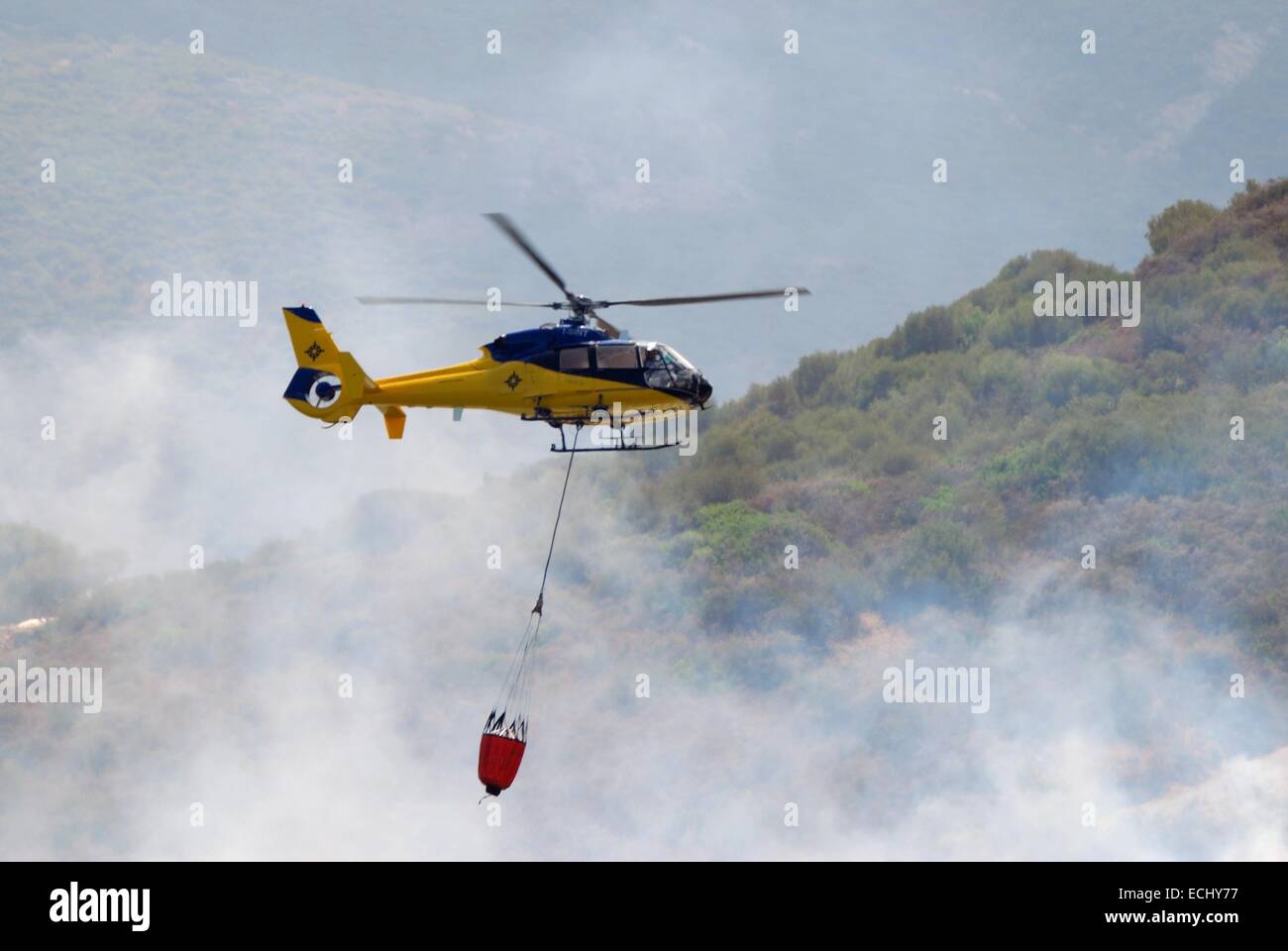 Firefighting helicopter extinguishing fire Stock Photo - Alamy