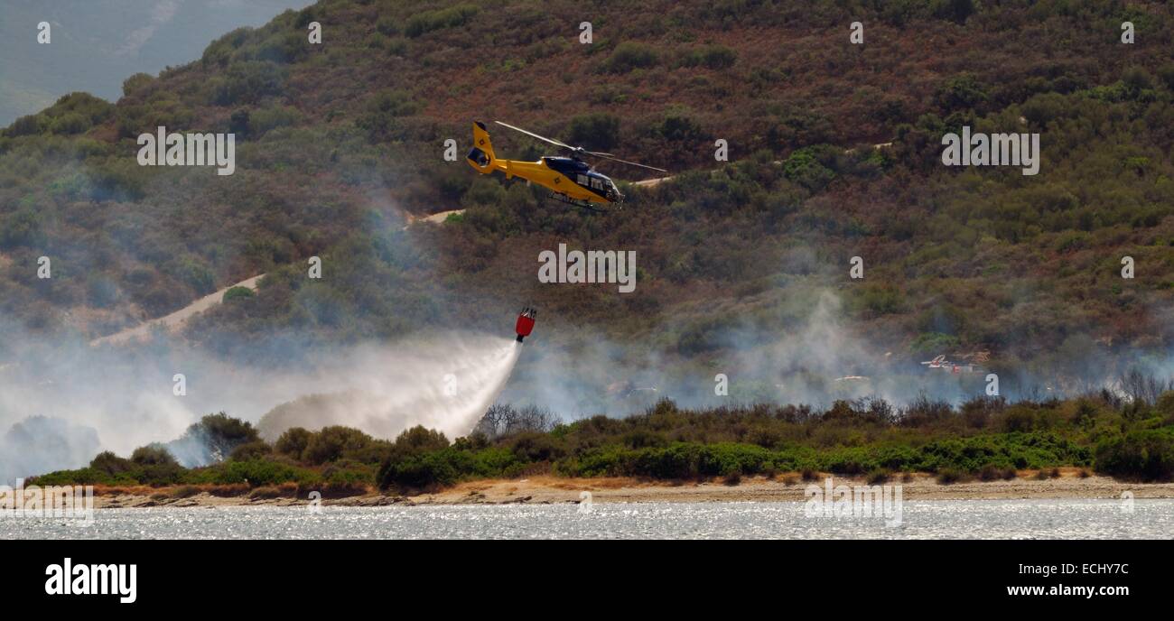 Firefighting helicopter extinguishing fire Stock Photo - Alamy