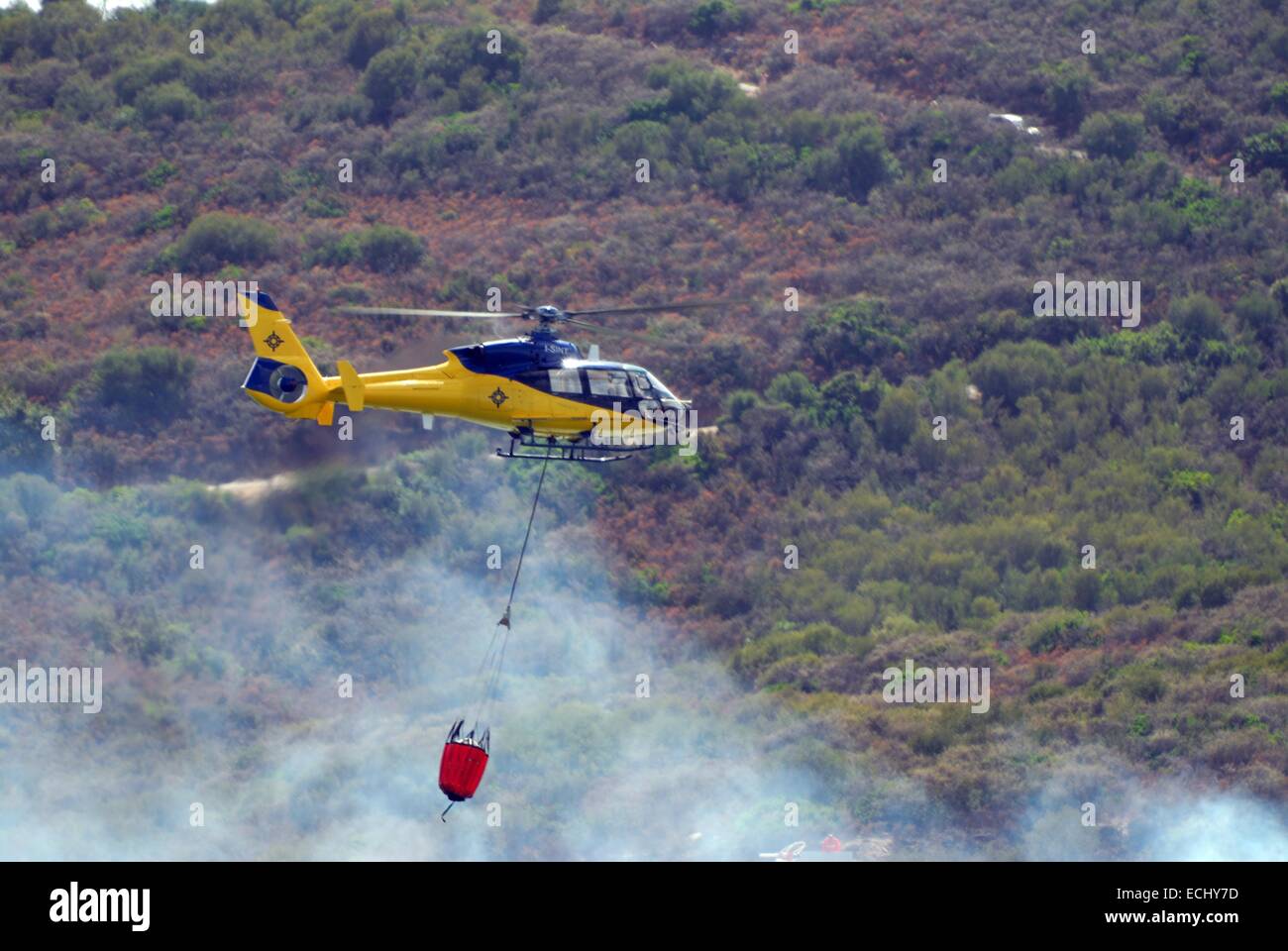 Firefighting helicopter extinguishing fire Stock Photo - Alamy