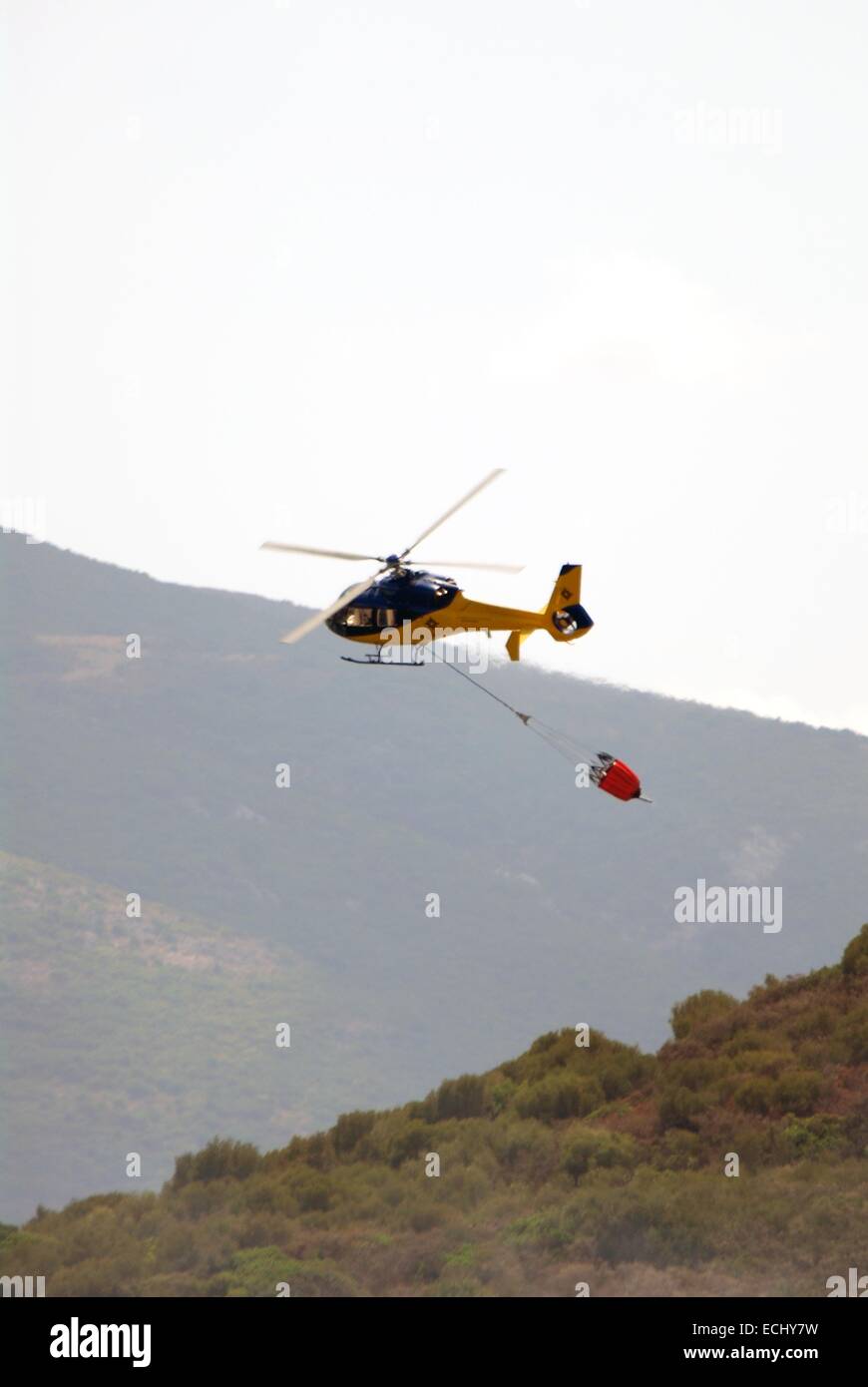 Firefighting helicopter extinguishing fire Stock Photo - Alamy