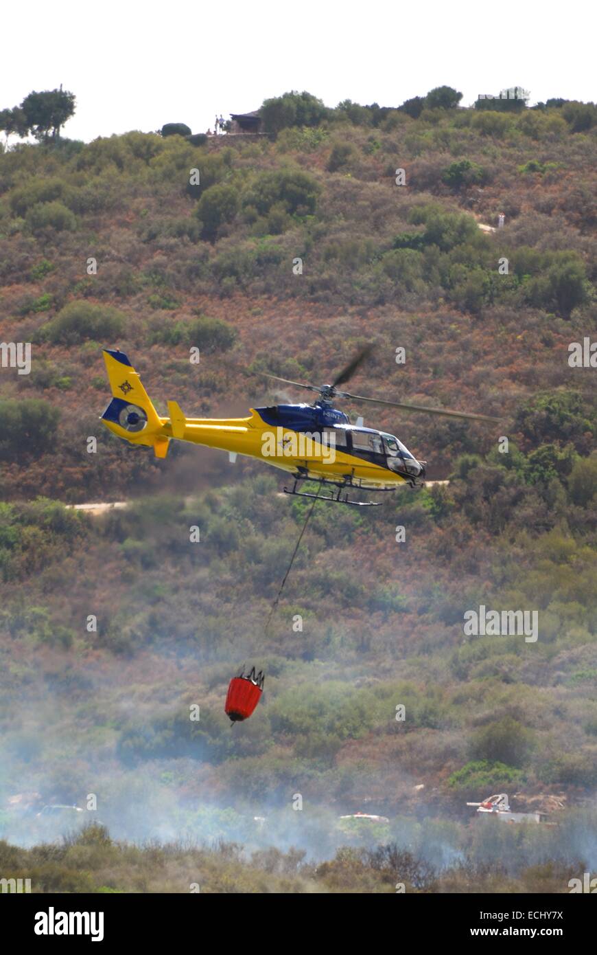 Firefighting helicopter extinguishing fire Stock Photo - Alamy