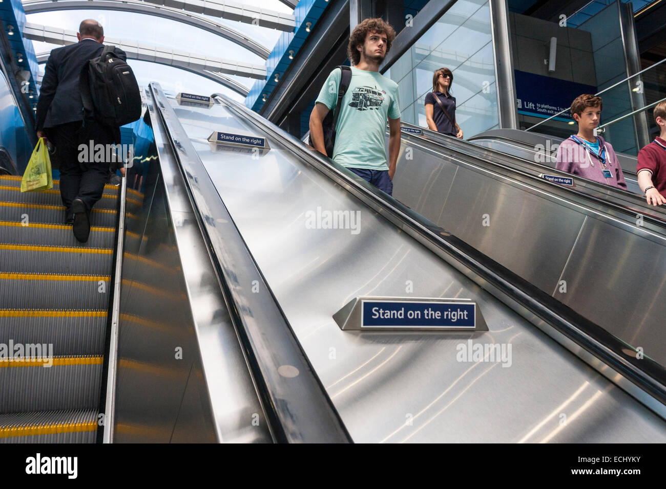 People on an escalator Stock Photo - Alamy
