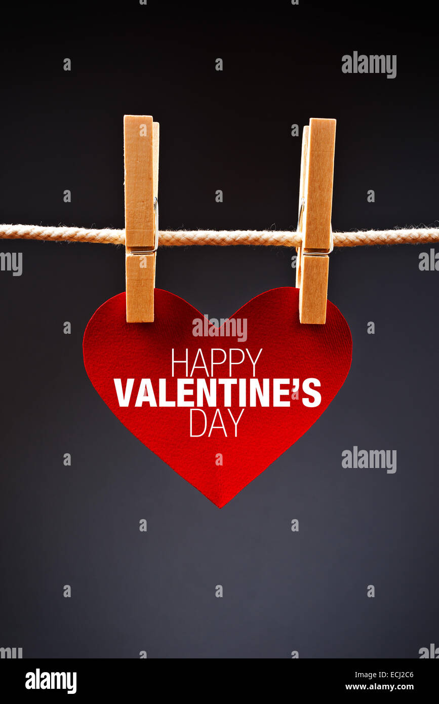 Heart shaped Valentine's Day card with message attached to a rope with ...