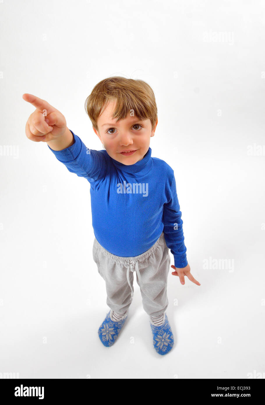 Cheerful little boy pointing up isolated Stock Photo - Alamy