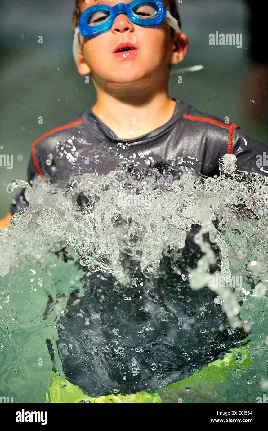 A young boy has fun playing in a swimming pool Stock Photo - Alamy