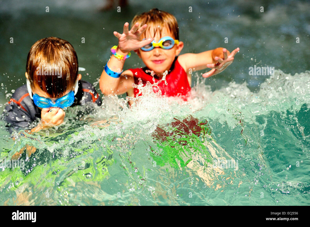 Two brothers play together in a swimming pool Stock Photo - Alamy