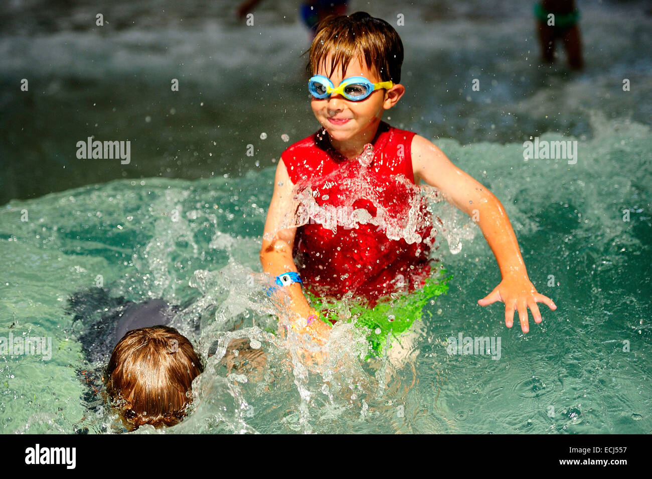 Two brothers play together in a swimming pool Stock Photo - Alamy
