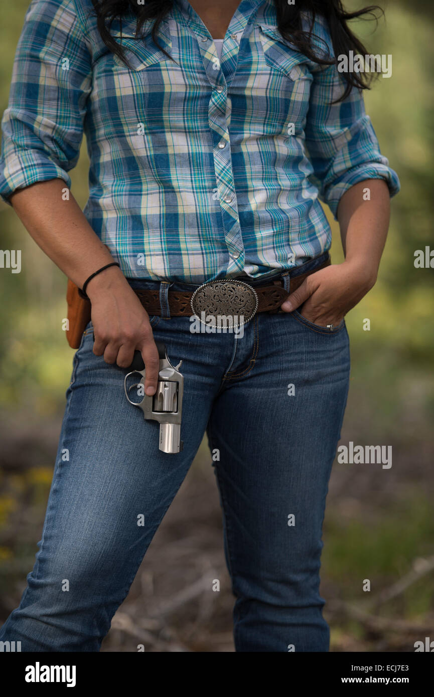 A western woman holds her revolver at ready Stock Photo - Alamy
