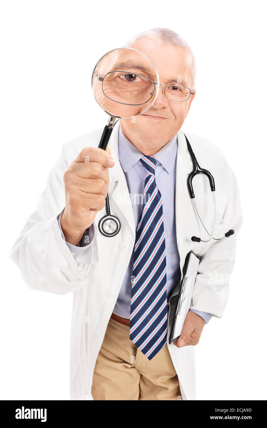 Mature doctor looking through a magnifying glass isolated on white ...