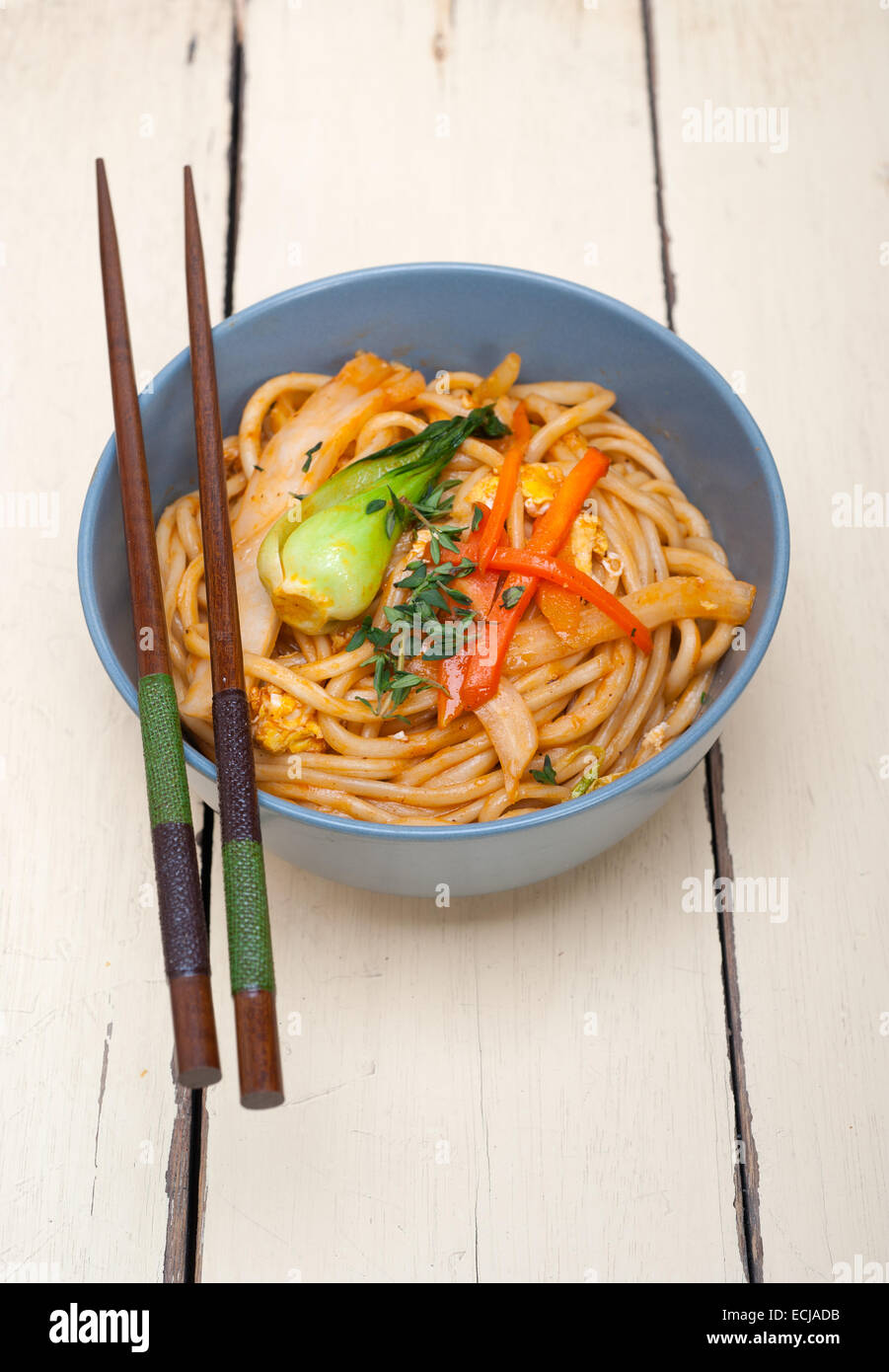 hand pulled stretched Chinese ramen noodles on a bowl with chopstick ...