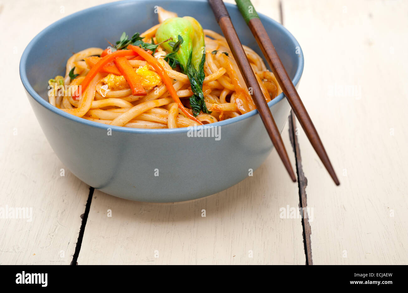 hand pulled stretched Chinese ramen noodles on a bowl with chopstick ...