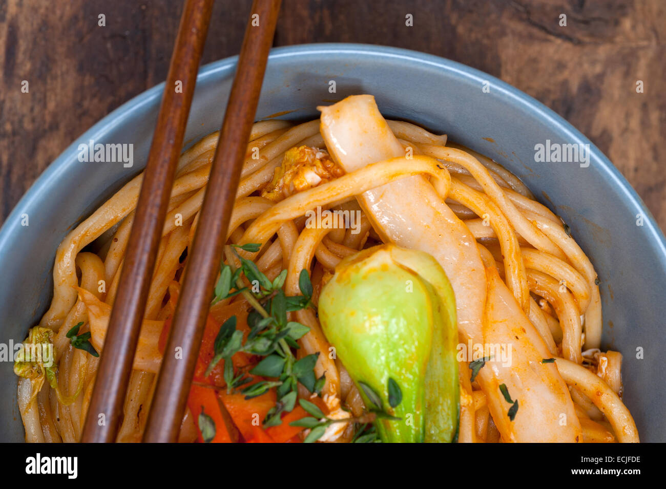 hand pulled stretched Chinese ramen noodles on a bowl with chopstick ...