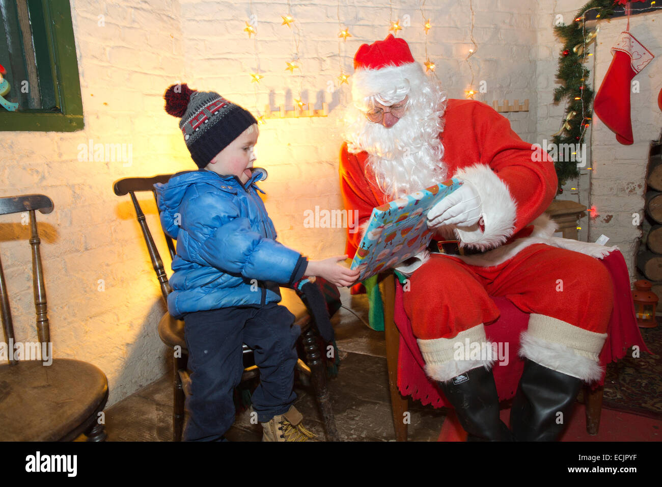 4 year old boy meeting Father Christmas in his grotto, England, UK ...