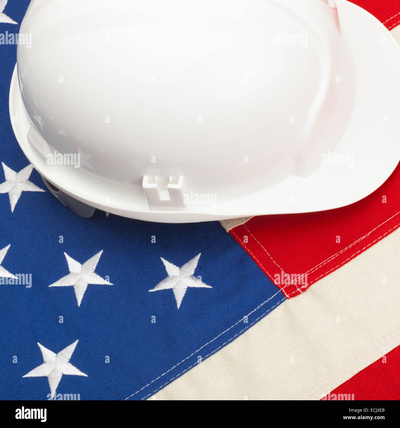 White color construction helmet laying over US flag - construction ...