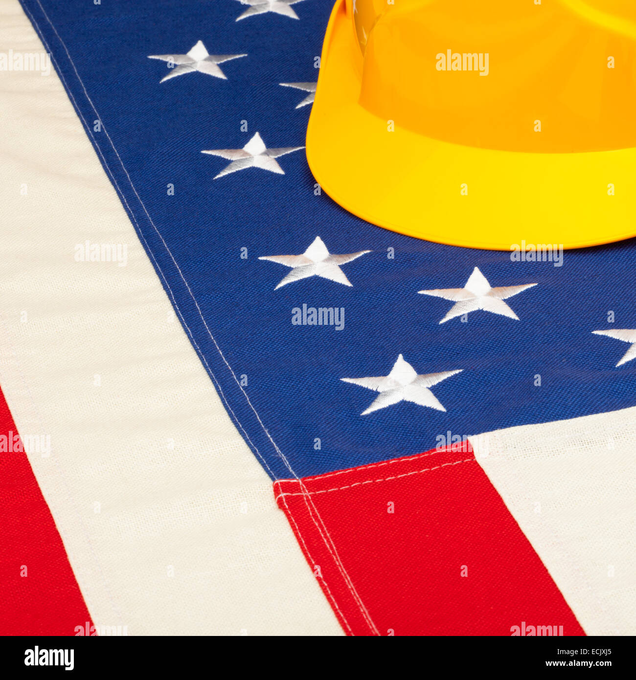 Construction helmet laying over US flag - construction industry concept ...