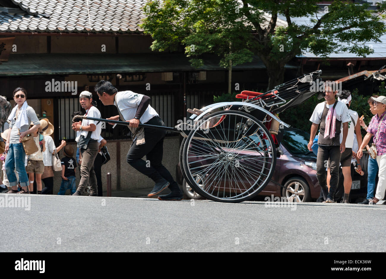 Nara, Japan. Tourists riding in rickshaws. The rickshaw-pullers are ...