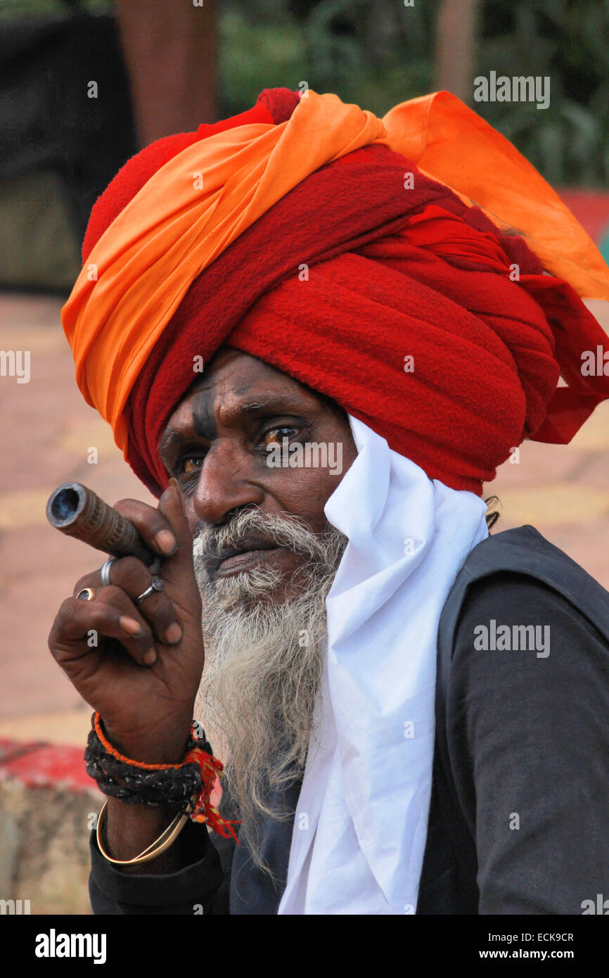 Baba or Sadhu in red turban smoking chillam or pipe Stock Photo - Alamy