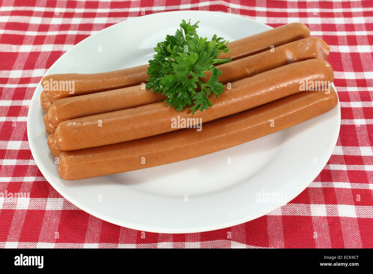 Wiener sausage on a plates with parsley Stock Photo - Alamy