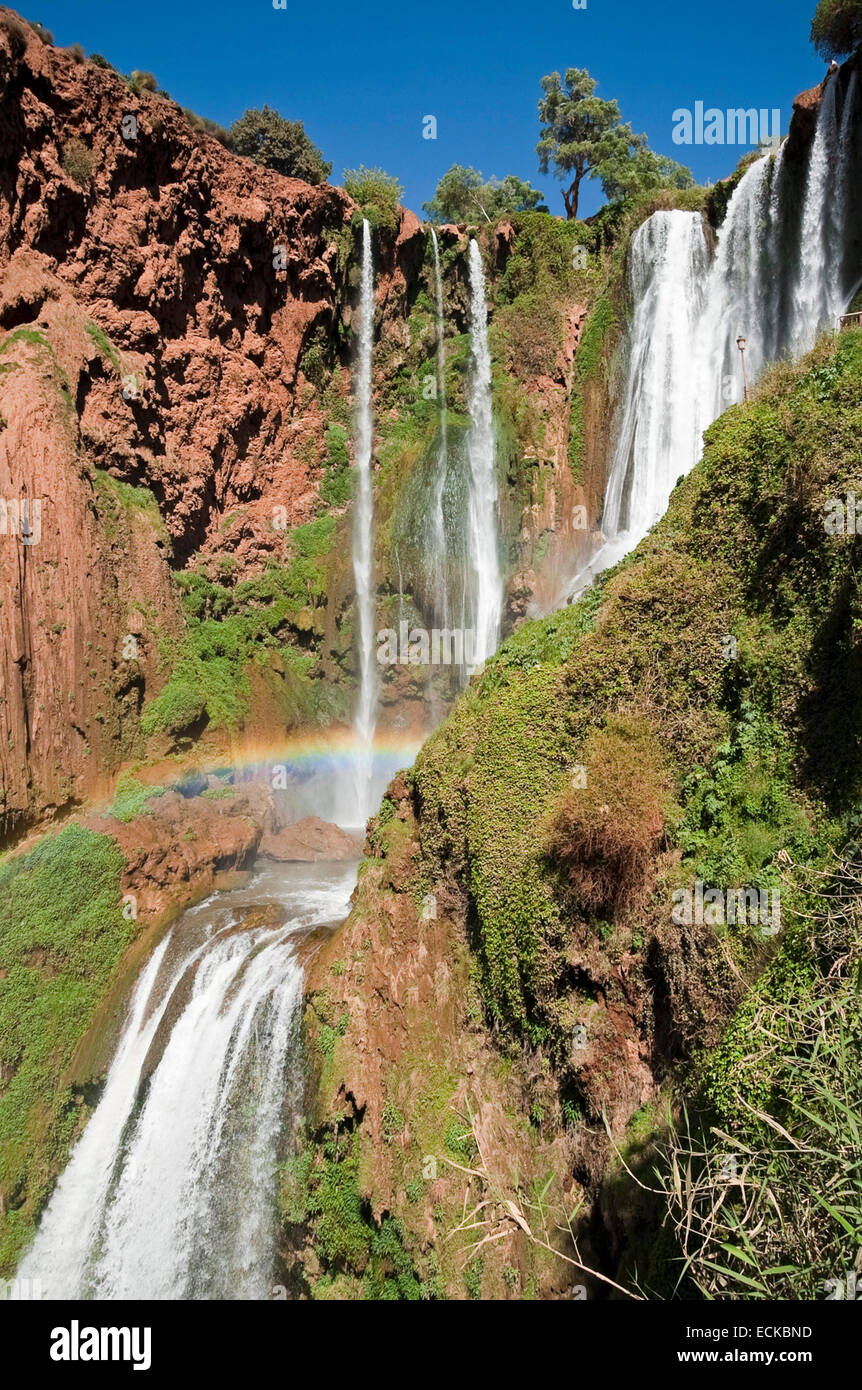 Vertical view of water spilling over Cascades d'Ouzoud on a sunny day ...