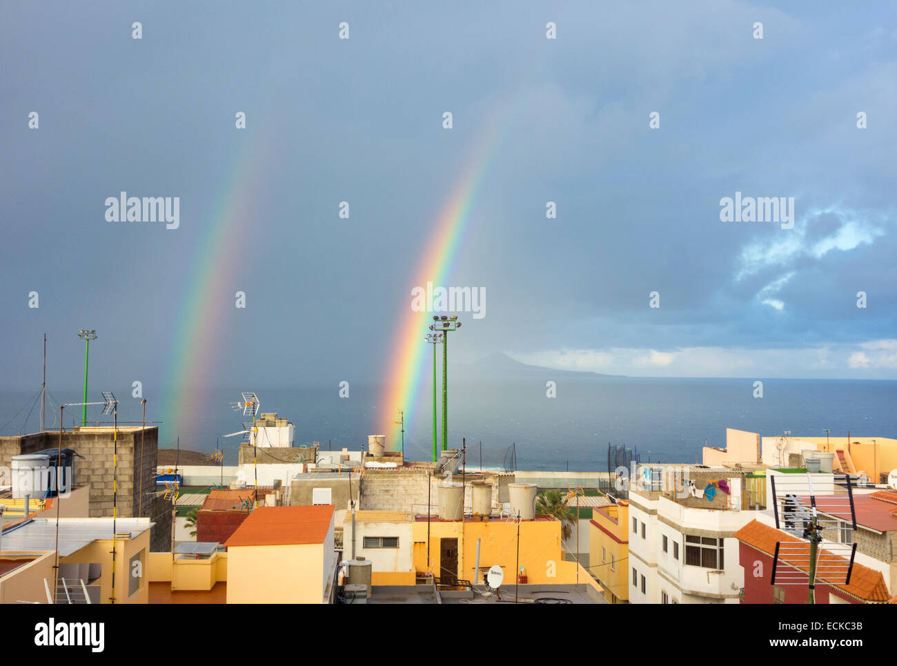 Double rainbow over rooftops and Atlantic ocean Stock Photo - Alamy