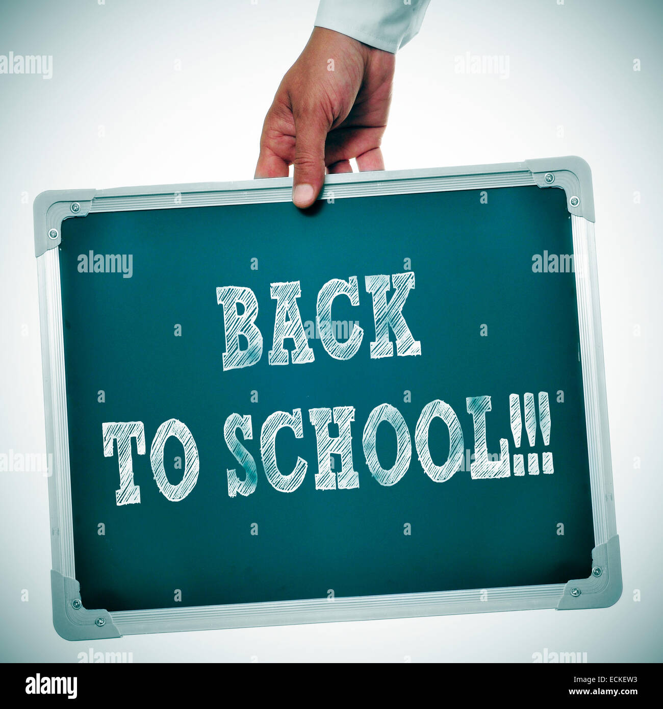 someone holding a chalkboard with the sentence back to school written ...