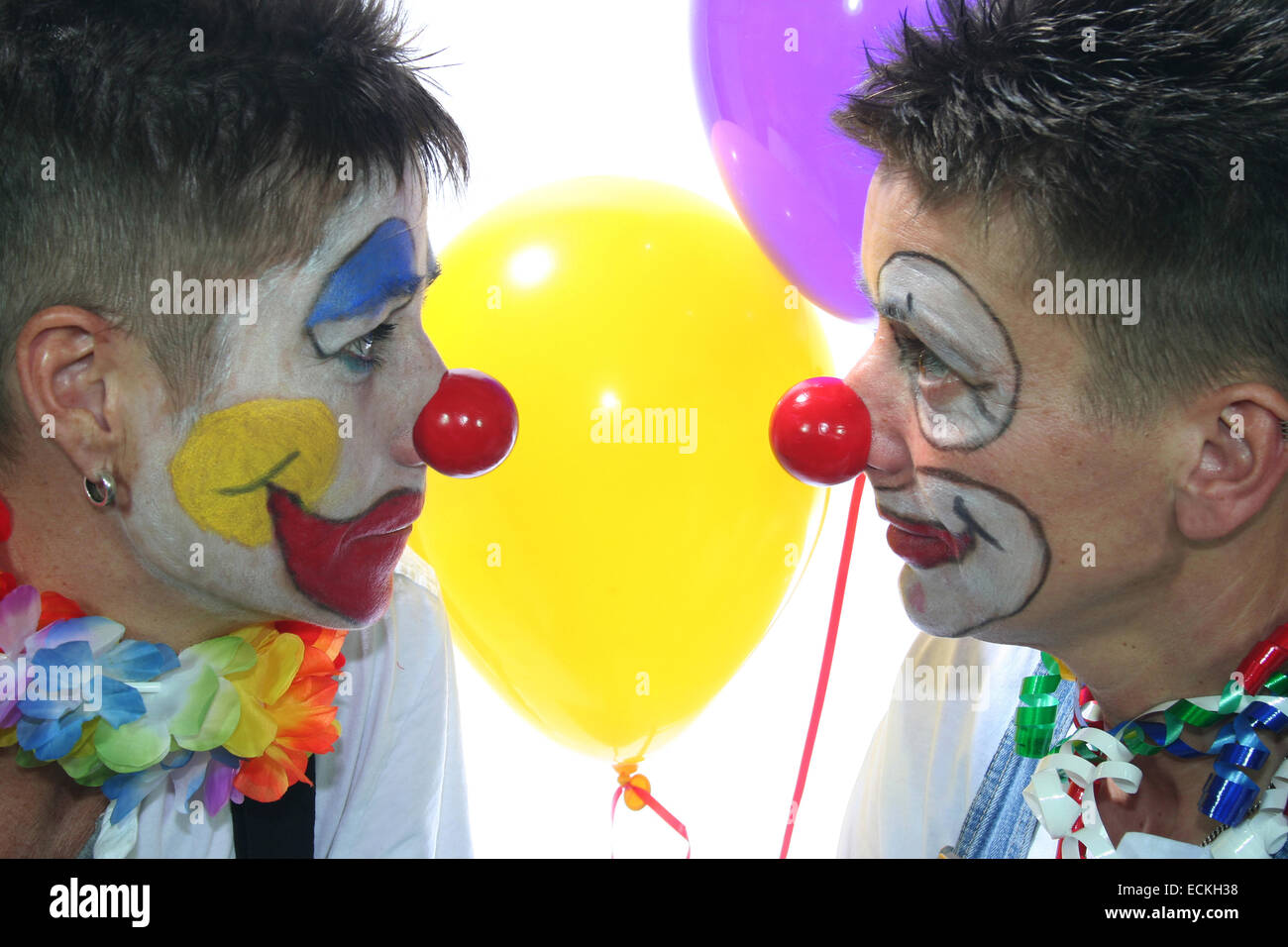 Two clowns look at each other with red nose Stock Photo - Alamy