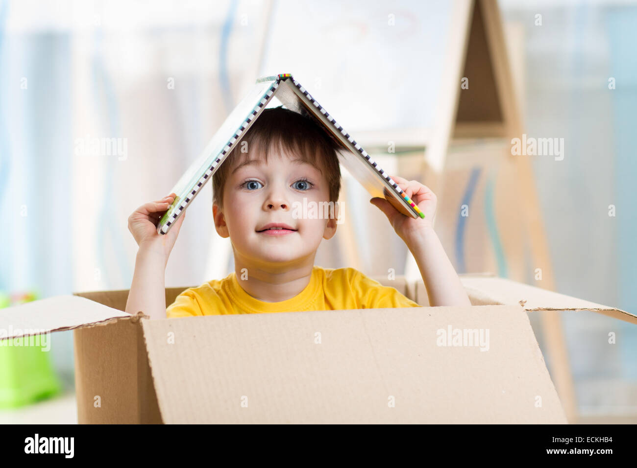 kid boy playing in a toy house Stock Photo - Alamy