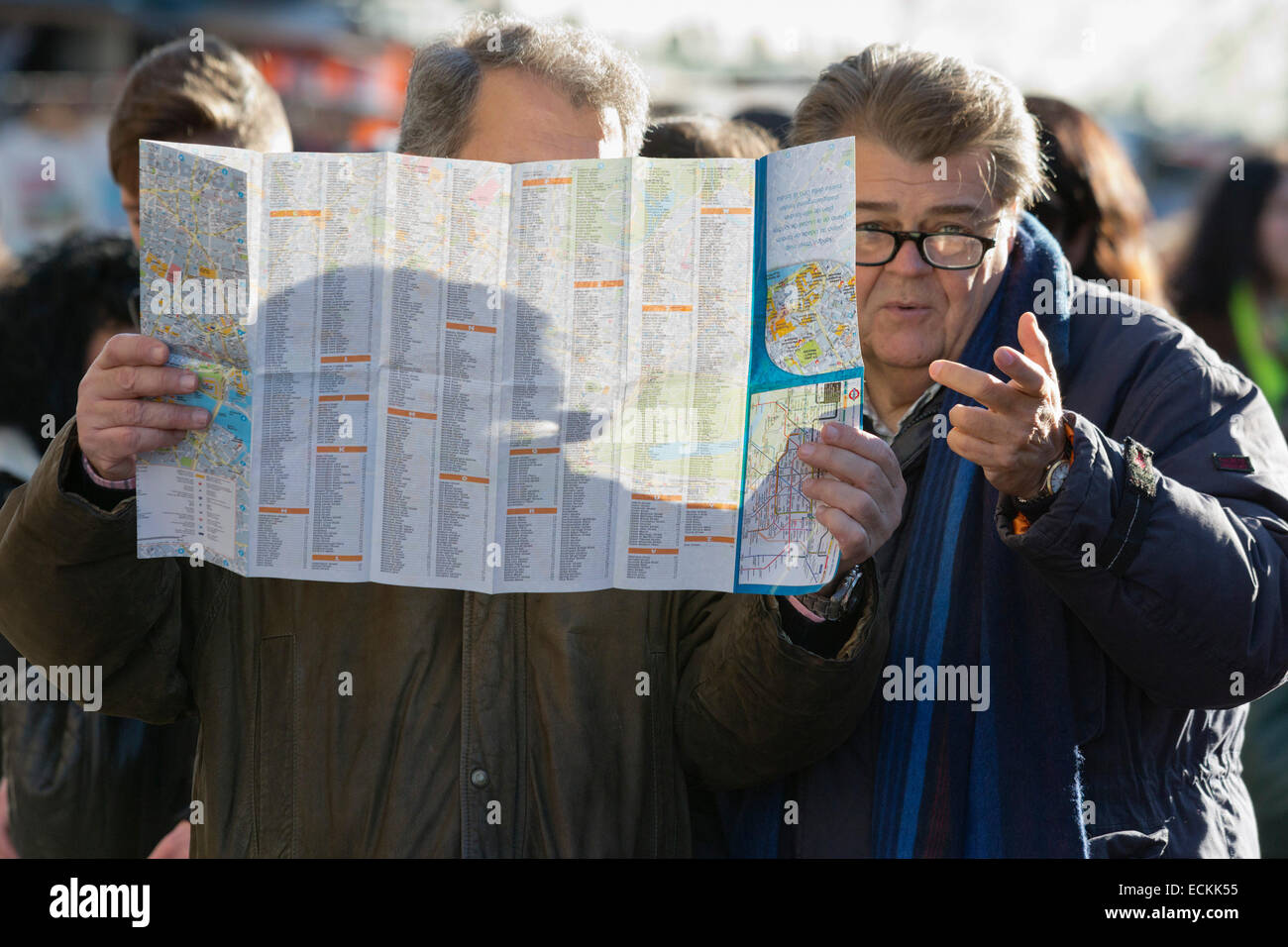 Tourists study a street map of London at Camden Market to find their ...
