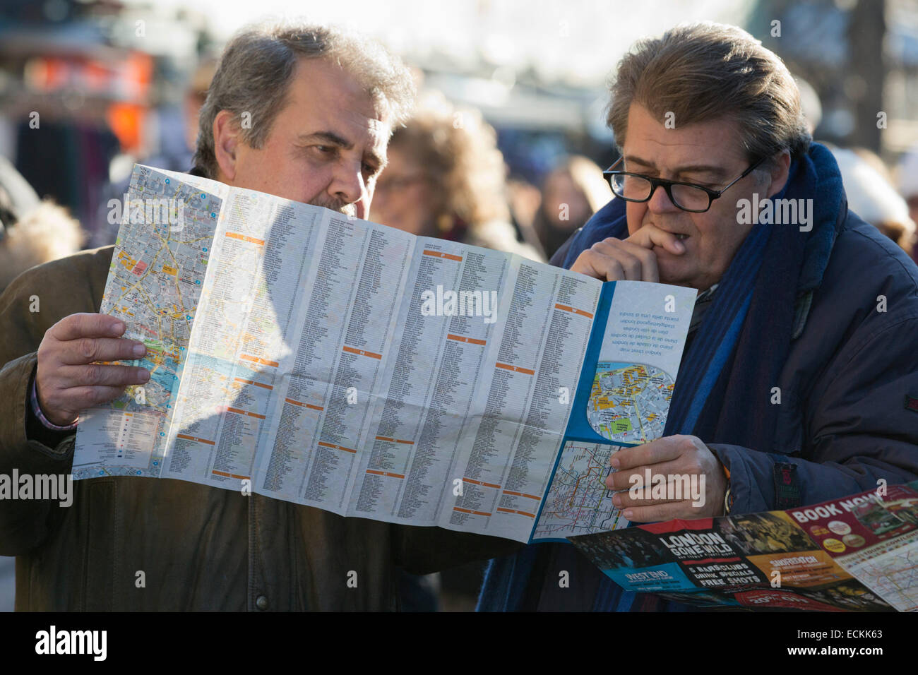Tourists study a street map of London at Camden Market to find their ...