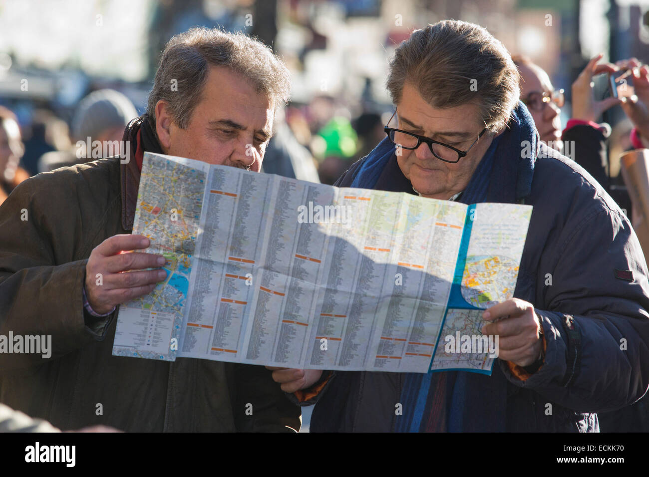 Tourists study a street map of London at Camden Market to find their ...