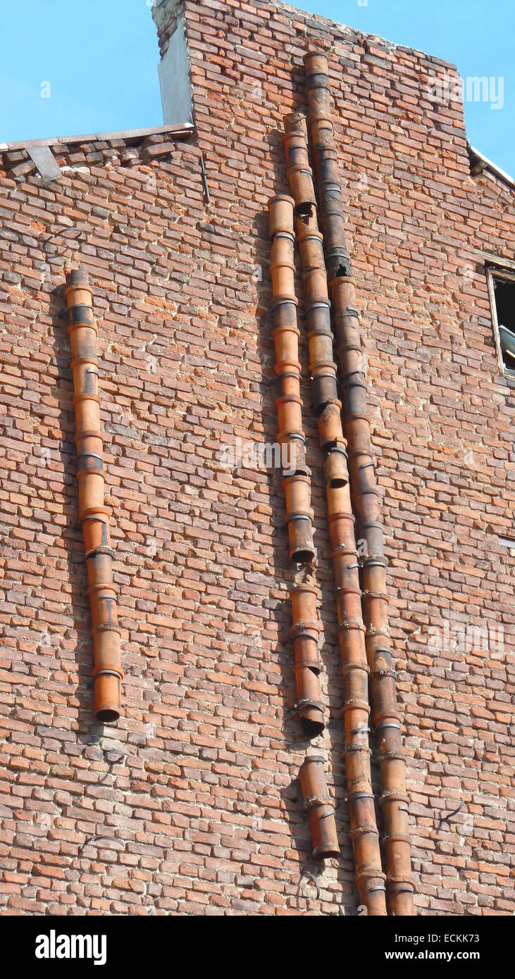 Remains of an old eaves-trough attached to brick building Stock Photo ...