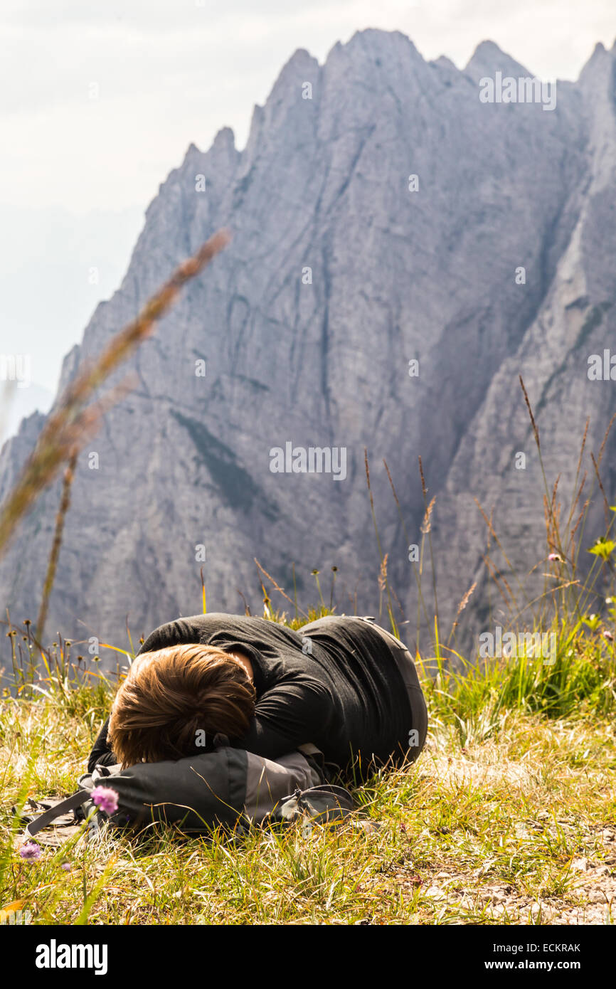 girl resting after the climb on the grass next to the path Stock Photo ...