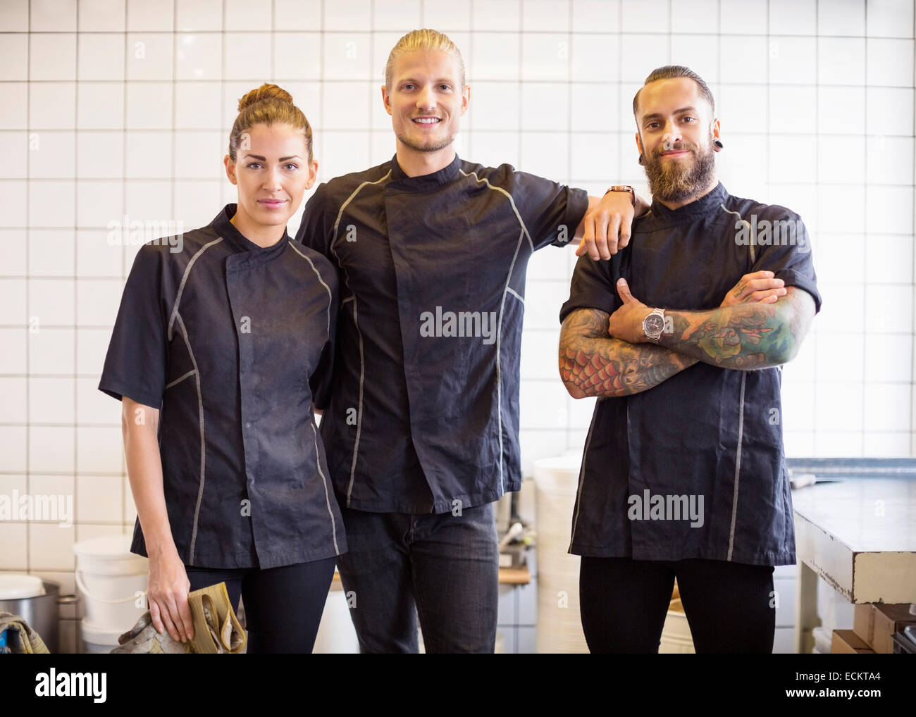 Portrait of smiling workers in candy store Stock Photo - Alamy