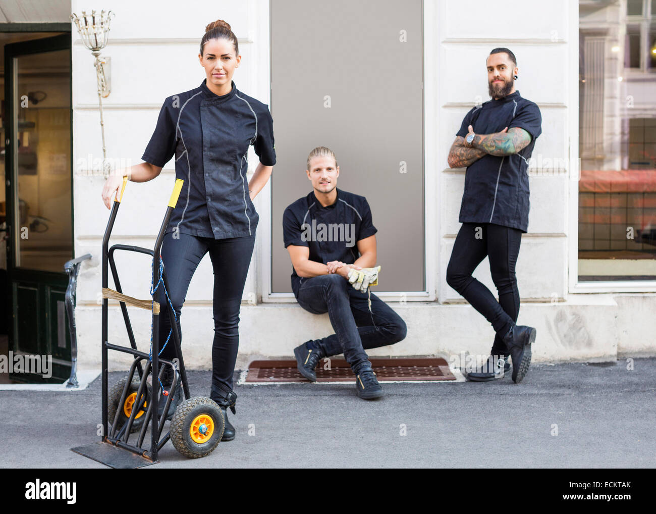 Full length portrait of workers standing outside candy store Stock ...