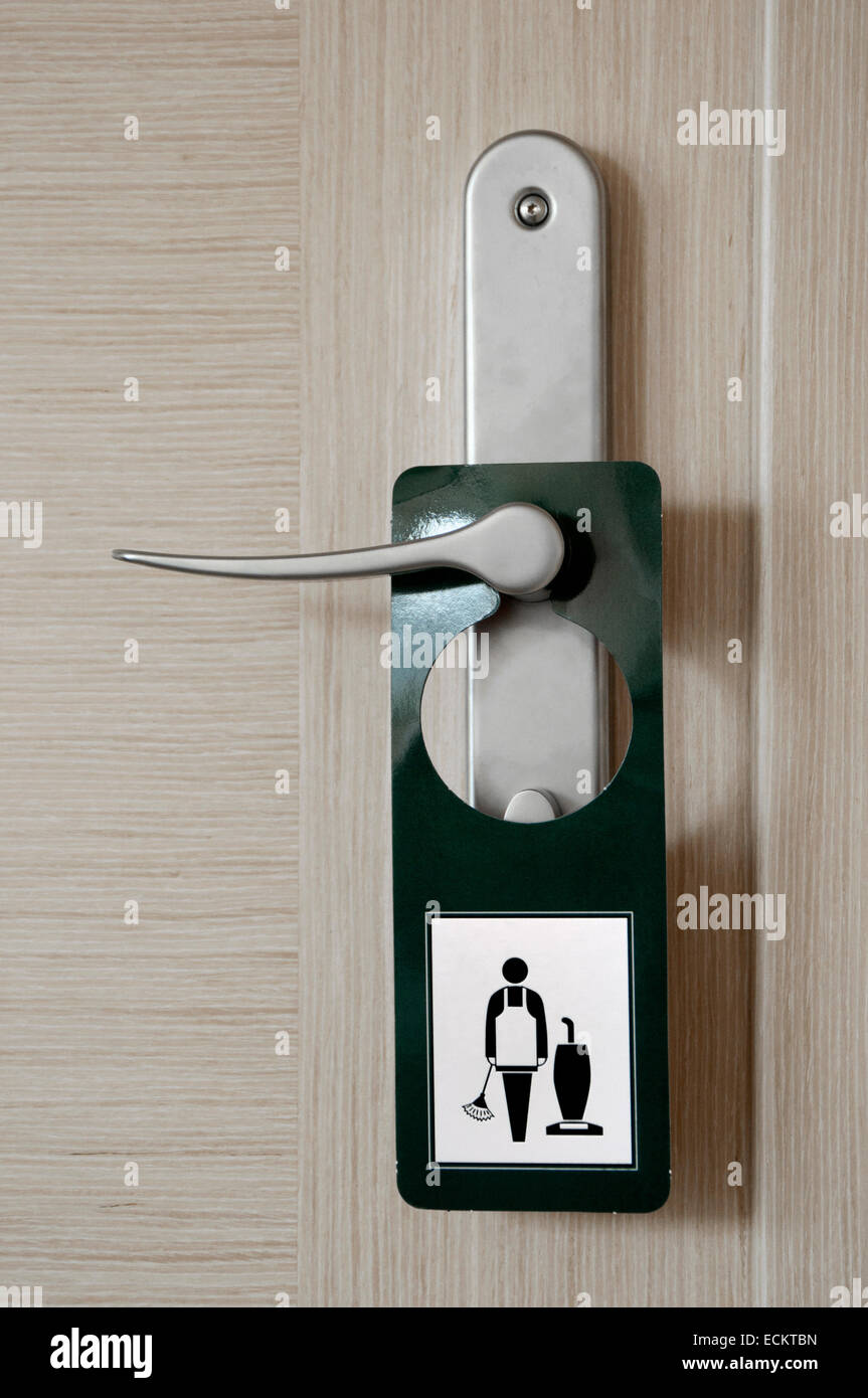 cardboard "please service room" hanging on the doorknob of a hotel ...