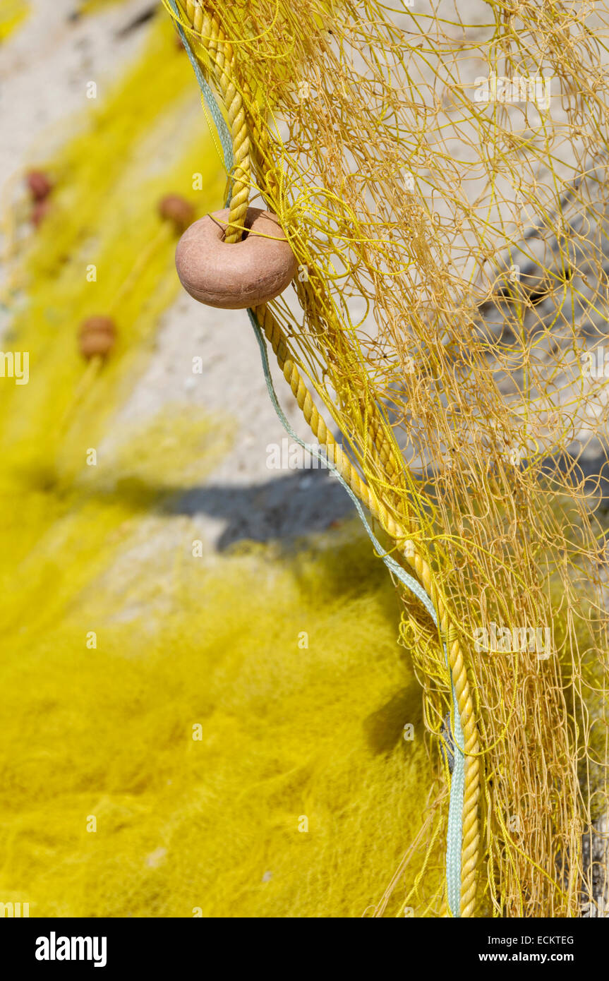 close up of float on yellow fishing nets on beach Stock Photo - Alamy