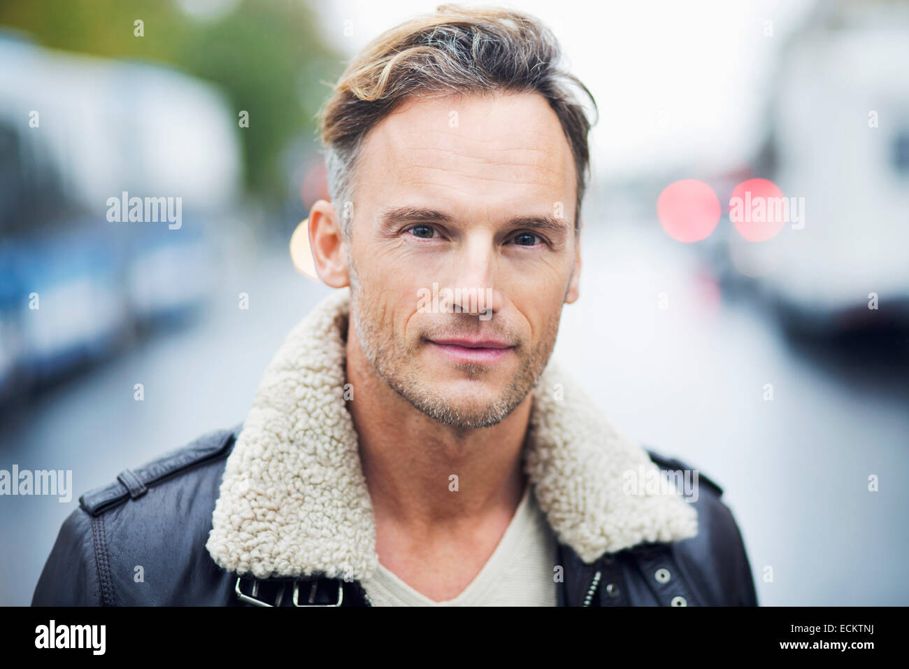 Portrait of confident mature man standing on street Stock Photo - Alamy