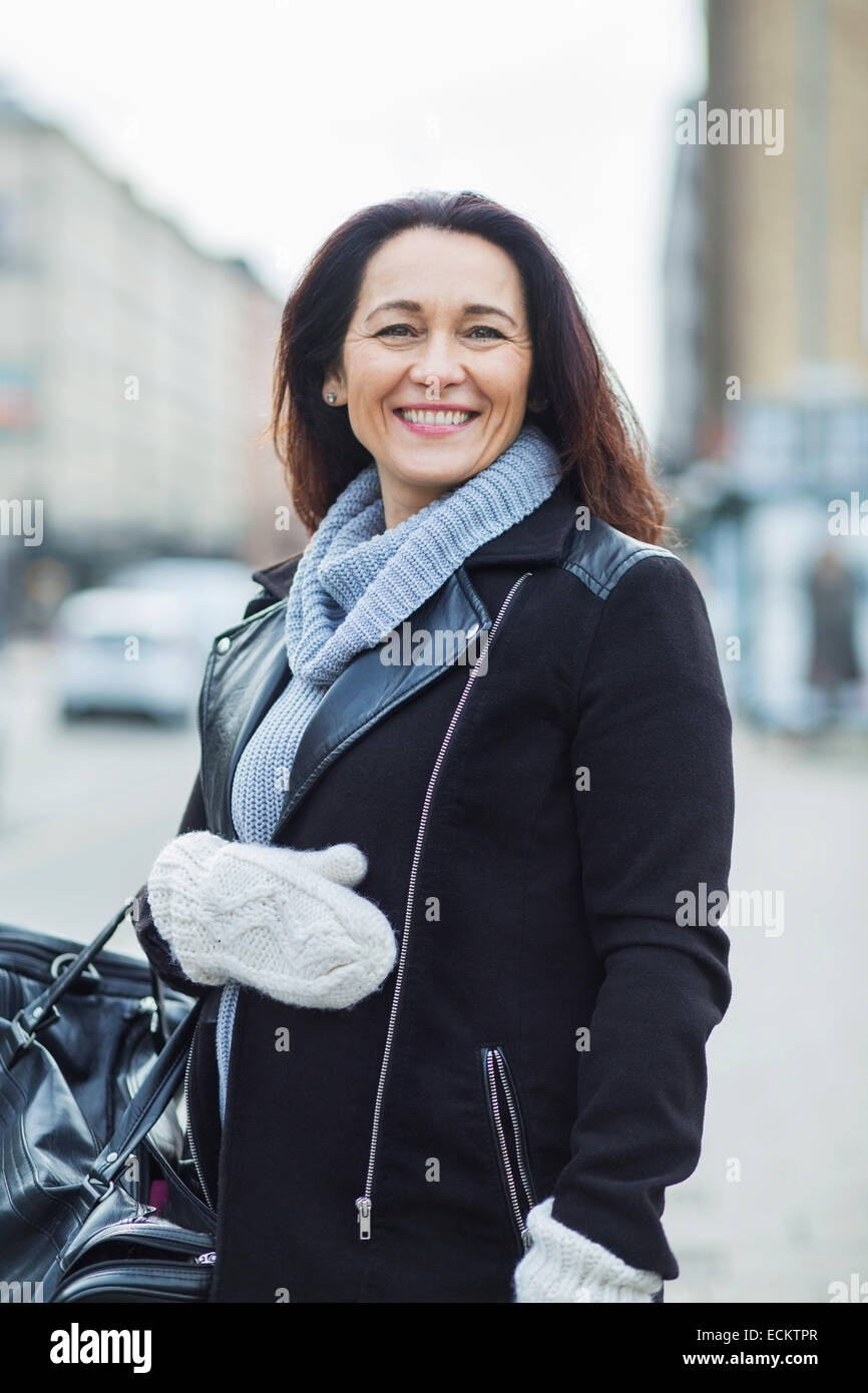 Portrait of smiling woman on standing on street in city Stock Photo - Alamy