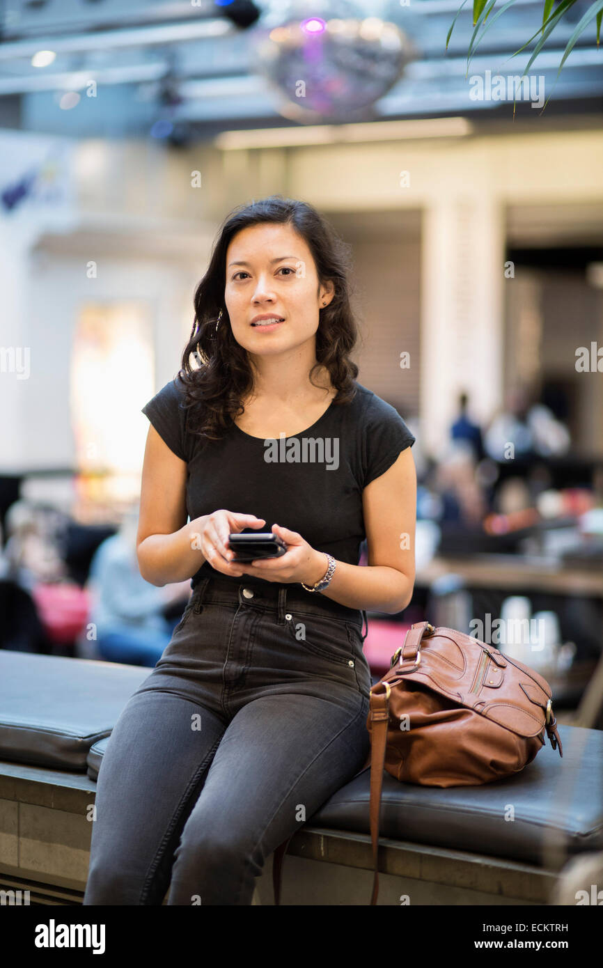 Portrait of woman using mobile phone in restaurant Stock Photo - Alamy