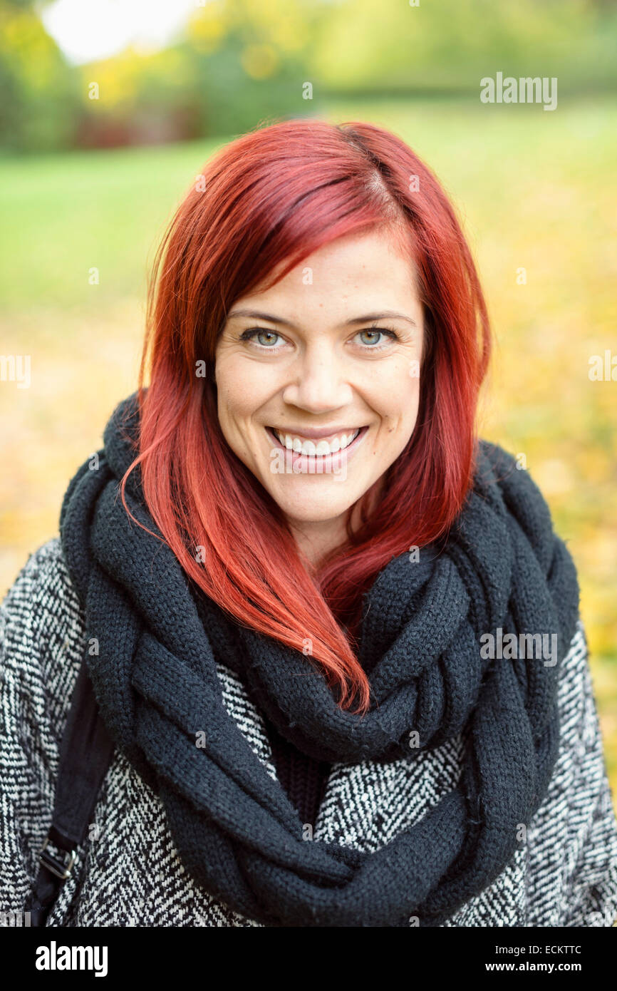 Portrait happy mid adult woman in park Stock Photo - Alamy