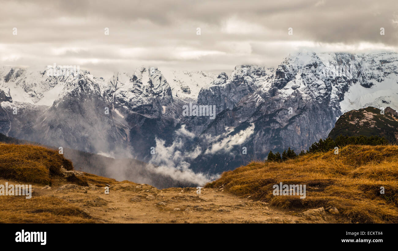 a mountain between the fog in the italian alps Stock Photo - Alamy