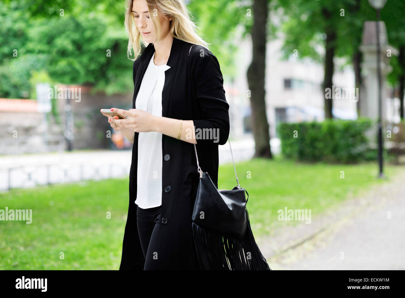 Cell phones people walking looking down hi-res stock photography and ...