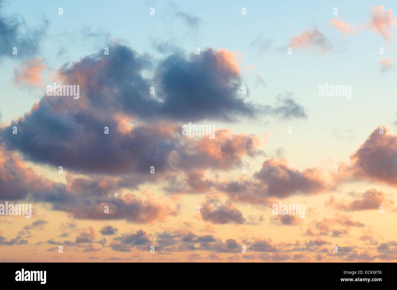 Background of sunset clouds in tropical colors in shades of pink and ...