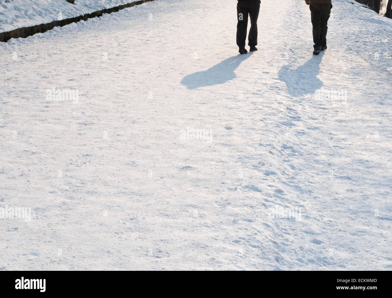 Two people walking on a footpath covered in snow Stock Photo - Alamy