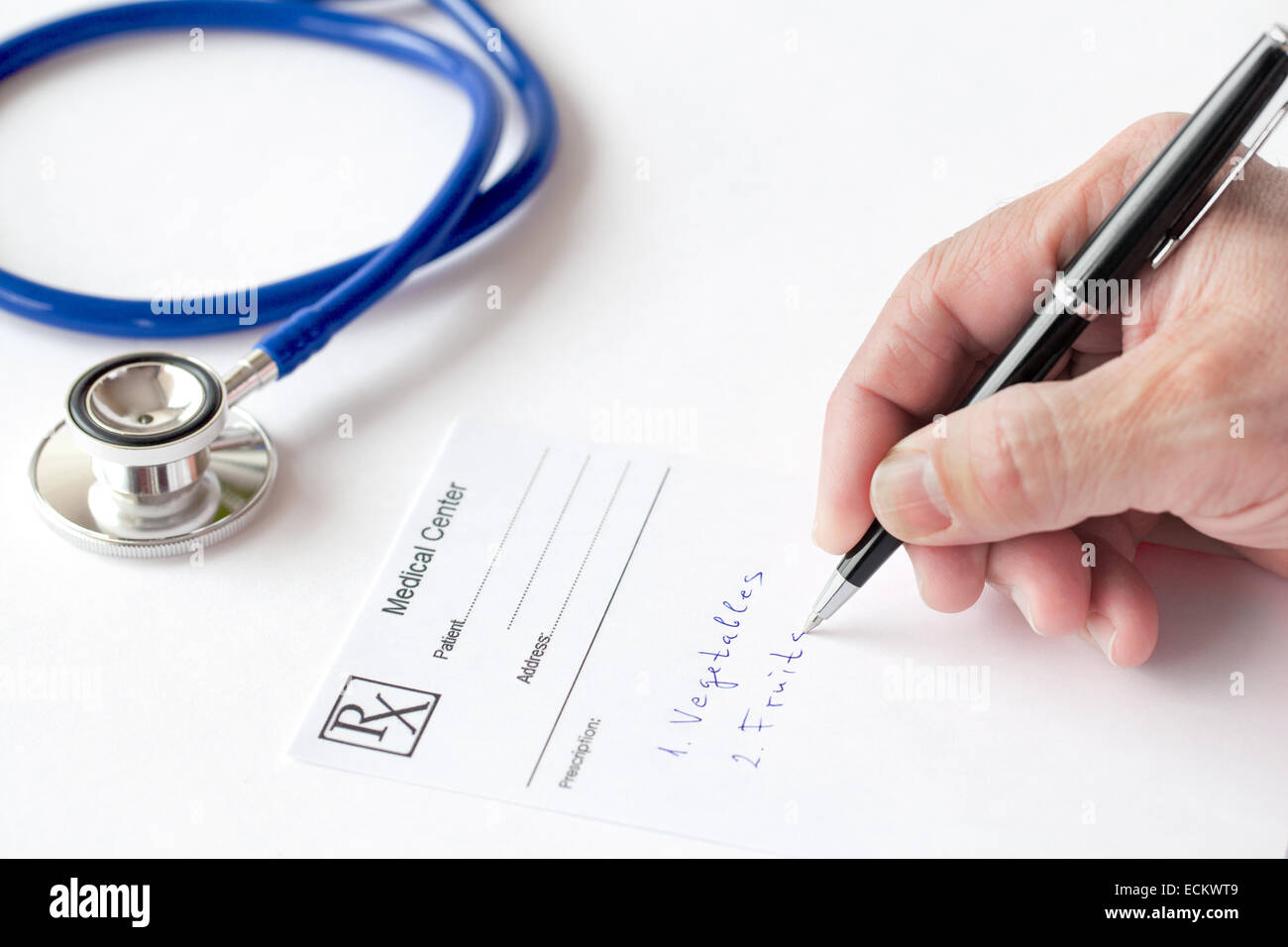 Doctor is writing a recipe for vegetables and fruits Stock Photo - Alamy