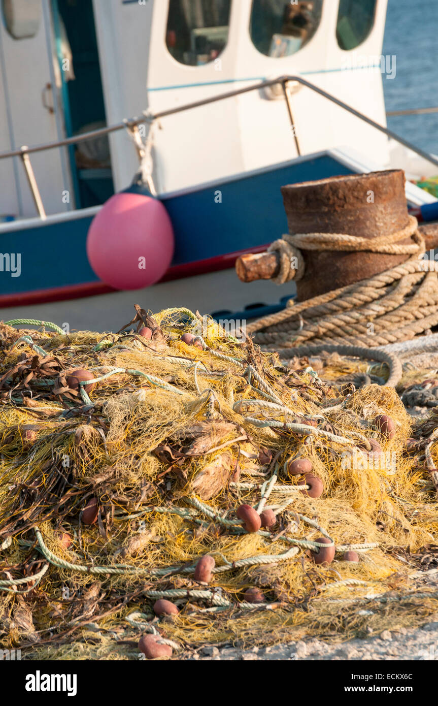 fishing nets piled up on the pier Stock Photo - Alamy