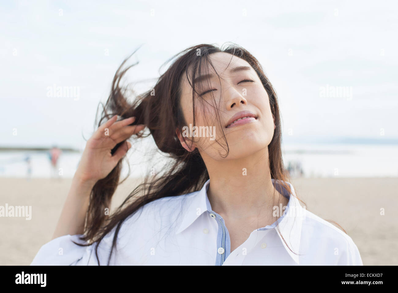 A woman on a beach in Kobe Stock Photo - Alamy