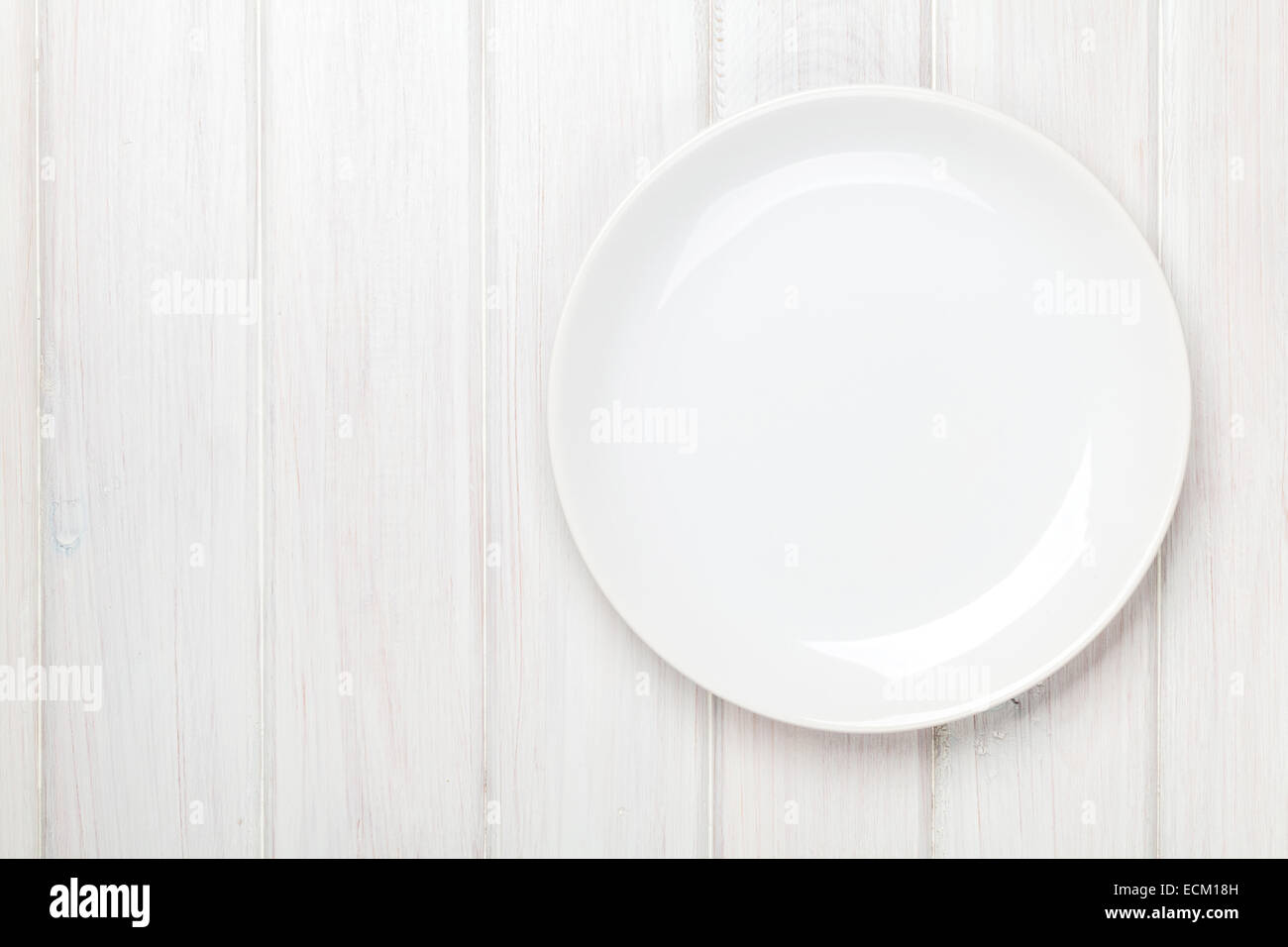 Empty plate over white wooden table background with copy space Stock ...