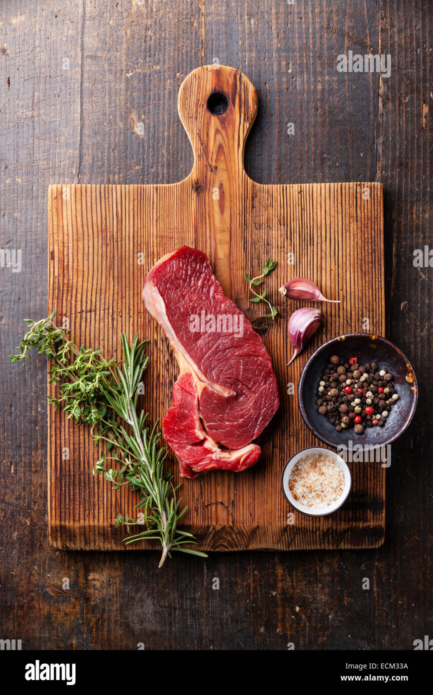 Raw fresh meat Ribeye steak entrecote and seasonings on cutting board ...