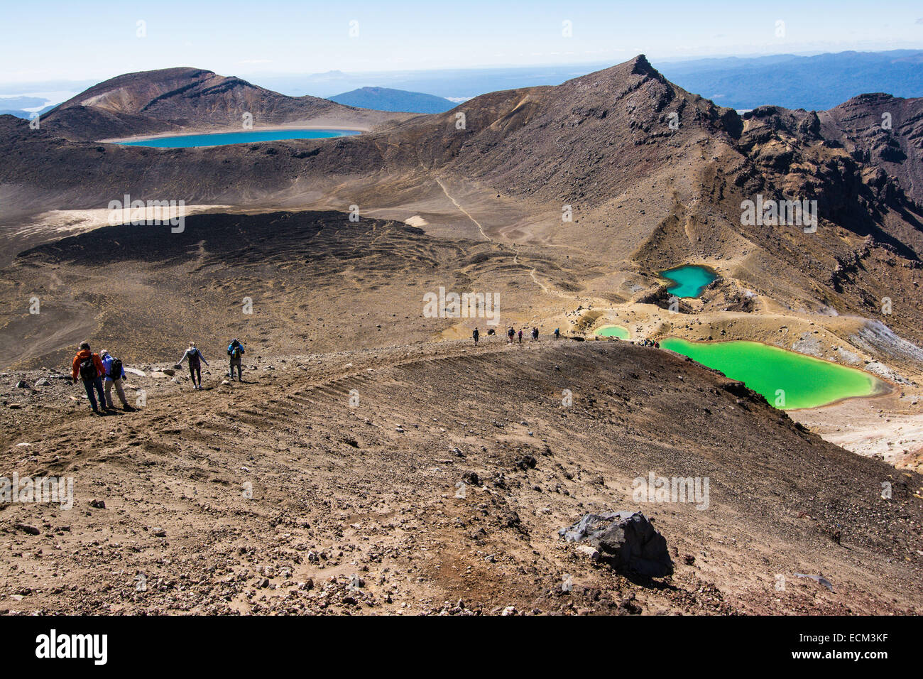 Hikers descending ridge to the Emerald Lakes, Northern Circuit hike ...